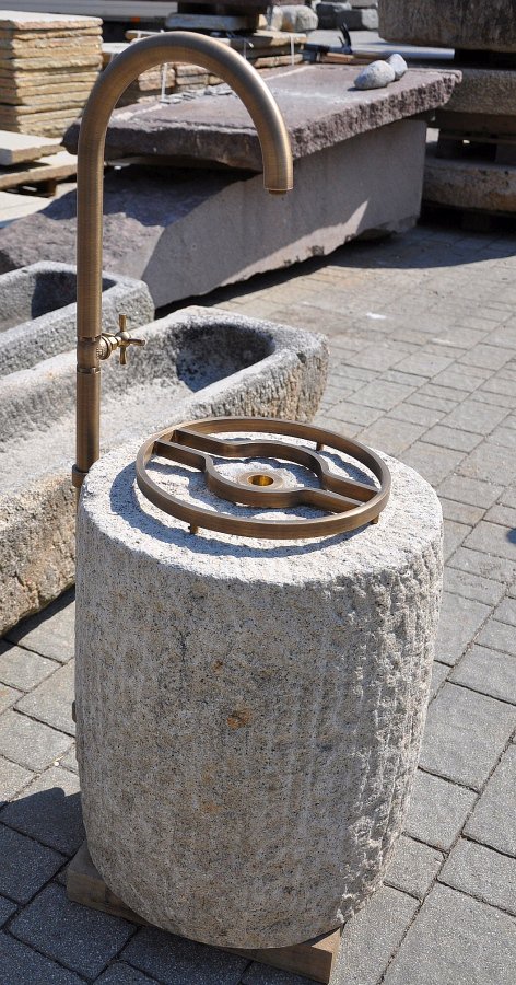Antique rolling stone with faucet, grate and drain